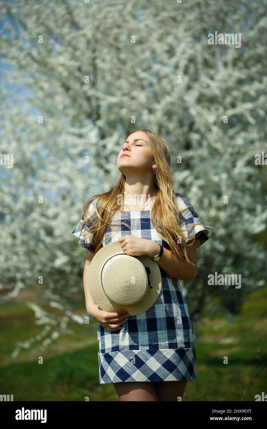 beautiful girl in a dress walking in the spring forest where the trees ...