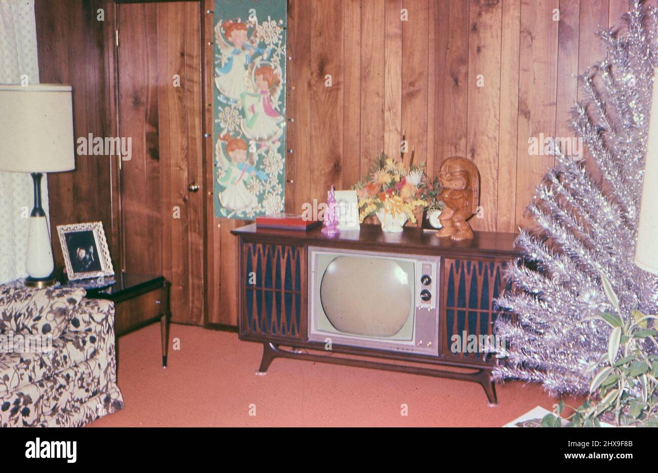 Paneled living room with console Television at Christmas time ca ...