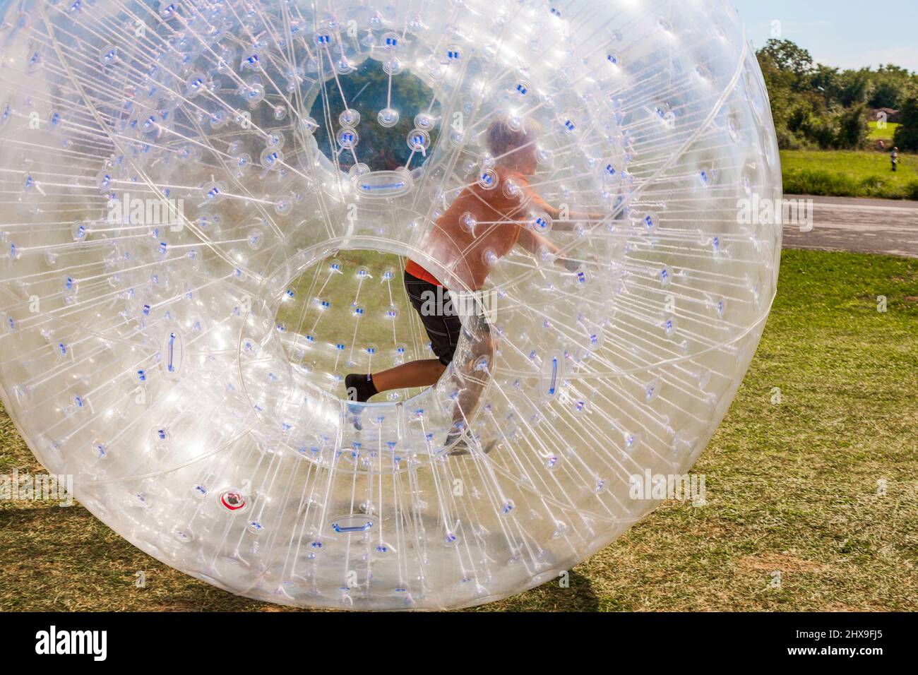 child has a lot of fun in the Zorbing Ball Stock Photo - Alamy