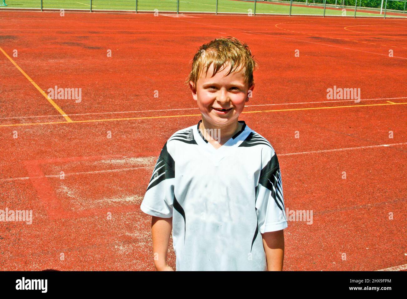 boy is sweating from soccer playing but looking happy and self ...