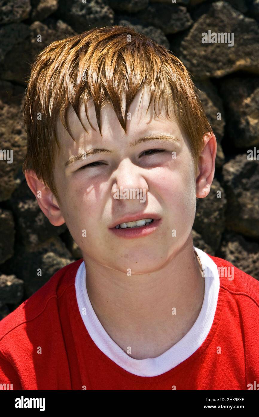 boy with red hair looks bored and angry Stock Photo - Alamy