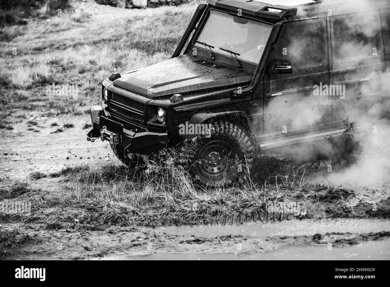 Low angle view of front of SUV on mountain road. Extreme off road tour ...