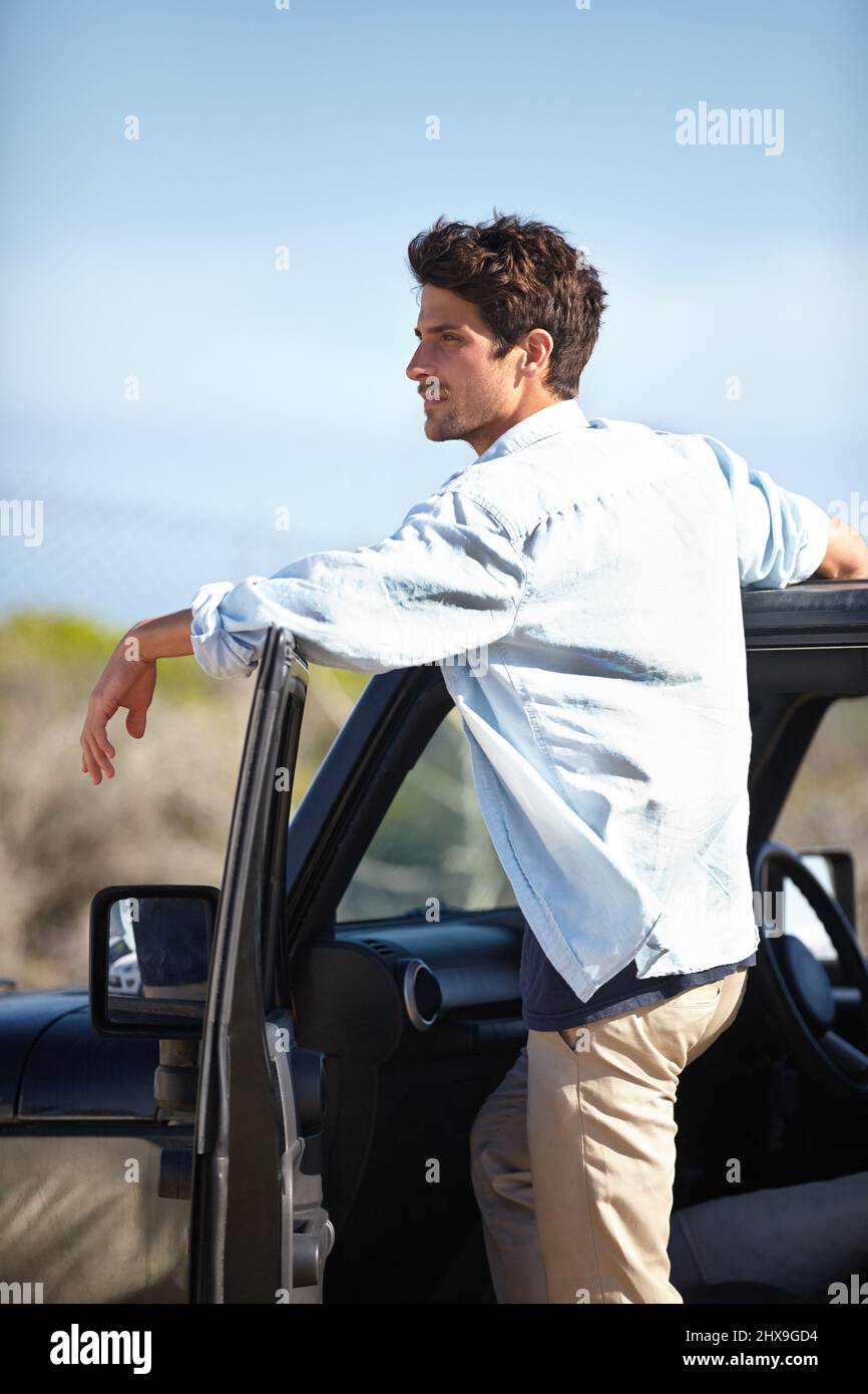 Soaking up the surroundings. A young man gazing into the distance Stock ...