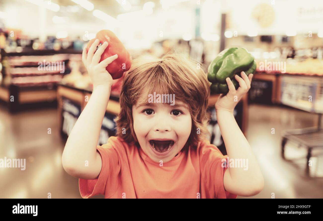 Cute toddler boy in a food store or a supermarket choosing fresh ...