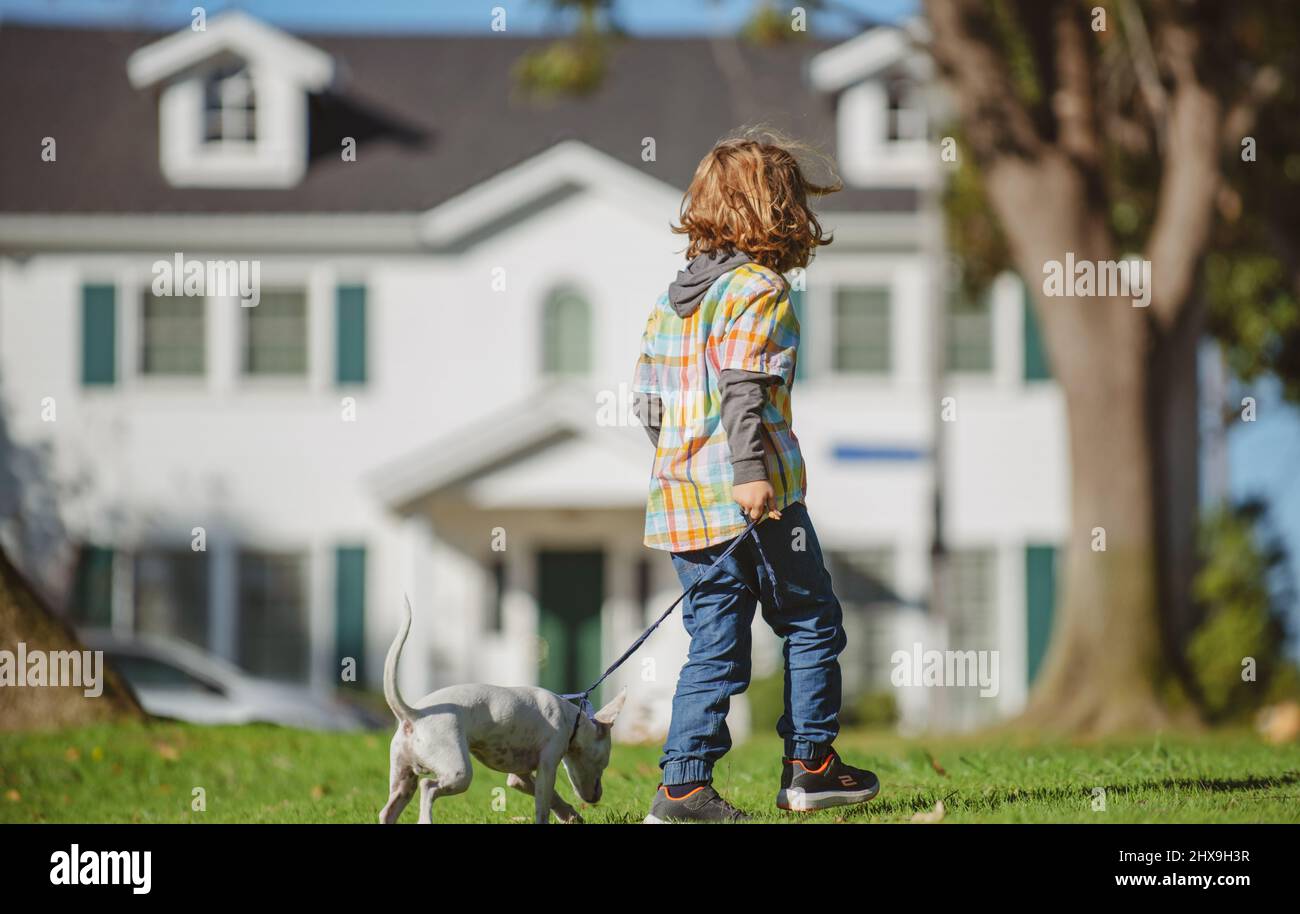 Happy child with dog. Kid boy with pet Stock Photo - Alamy