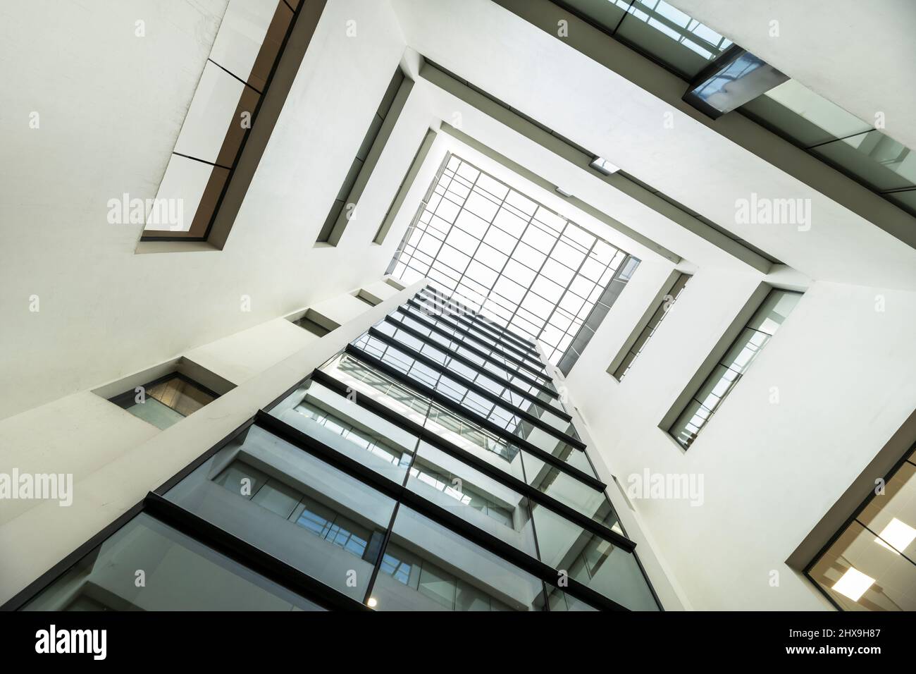 Atrium of an office building with a glass roof closure Stock Photo - Alamy