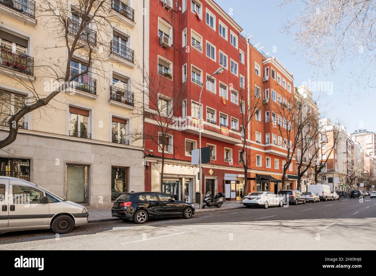Facades of residential buildings painted red in an avenue in the center ...