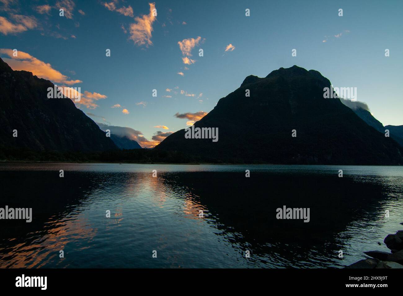 Water mirror reflection of mountain and twilight after sunset sky, New ...