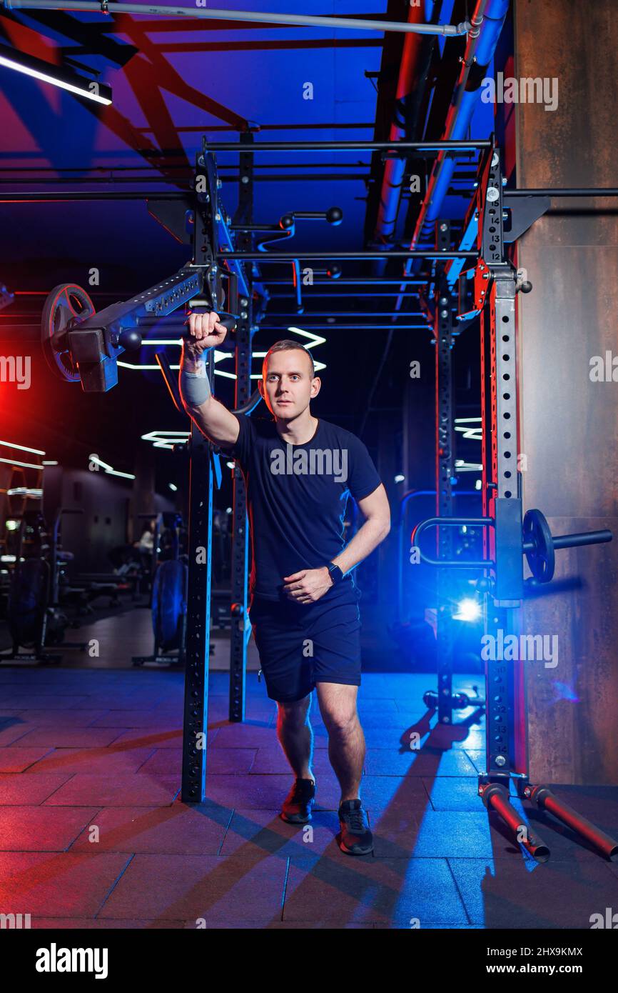 Muscular man doing heavy exercises in the modern gym. Sports in the gym ...