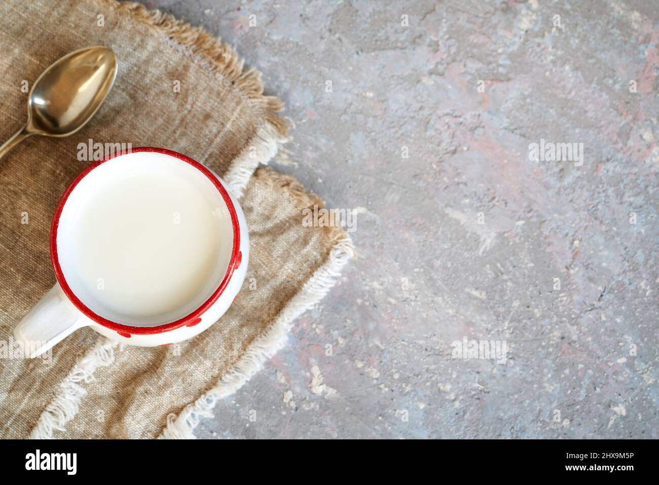 A cup of fresh milk kefir in a cup on gray background with copy space ...