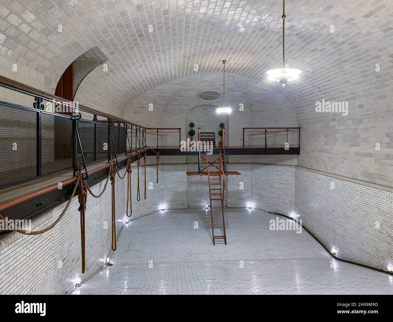 Large indoor tiled, underground, private swimming pool empty of water ...