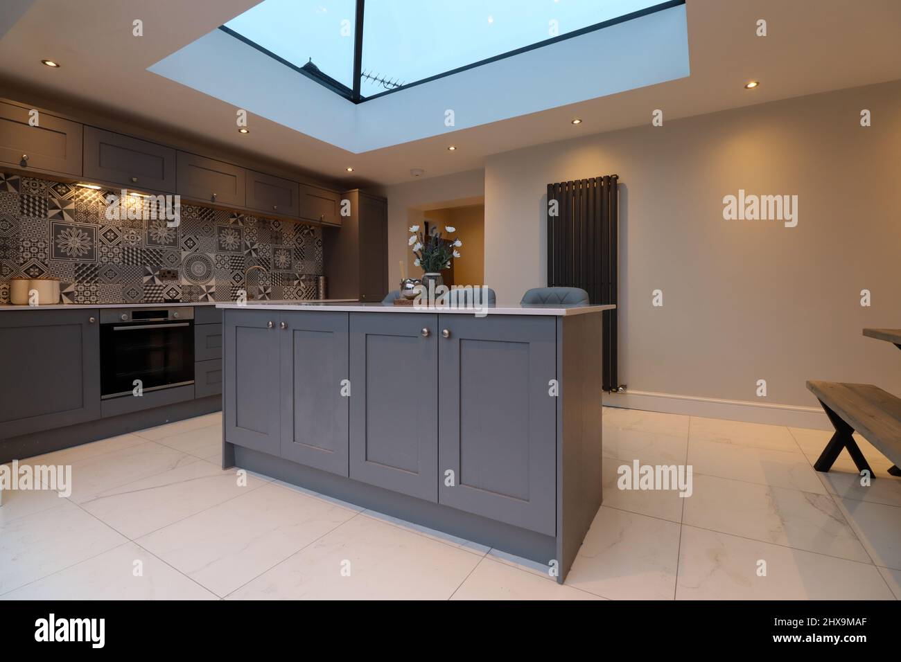 Ultra modern high end grey kitchen with lantern skylight and bi-fold ...
