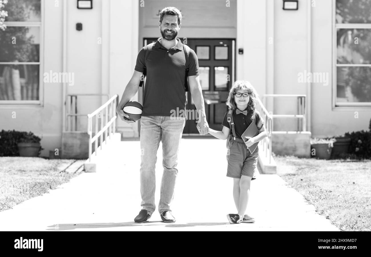 Father walking son to school. Parent and pupil of primary school ...