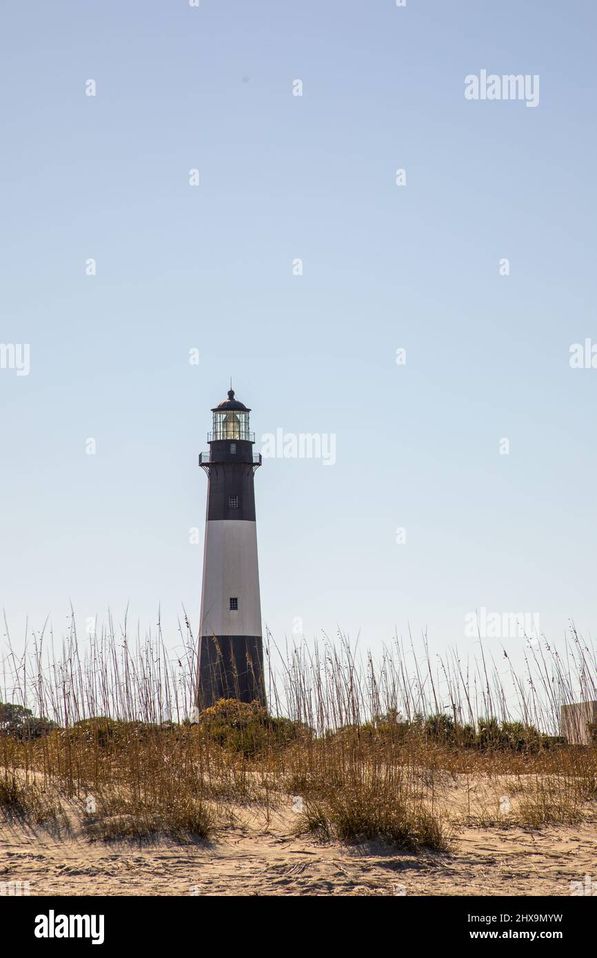 Tybee Island Lighthouse over sandy dunes along seashore of Tybee Island ...