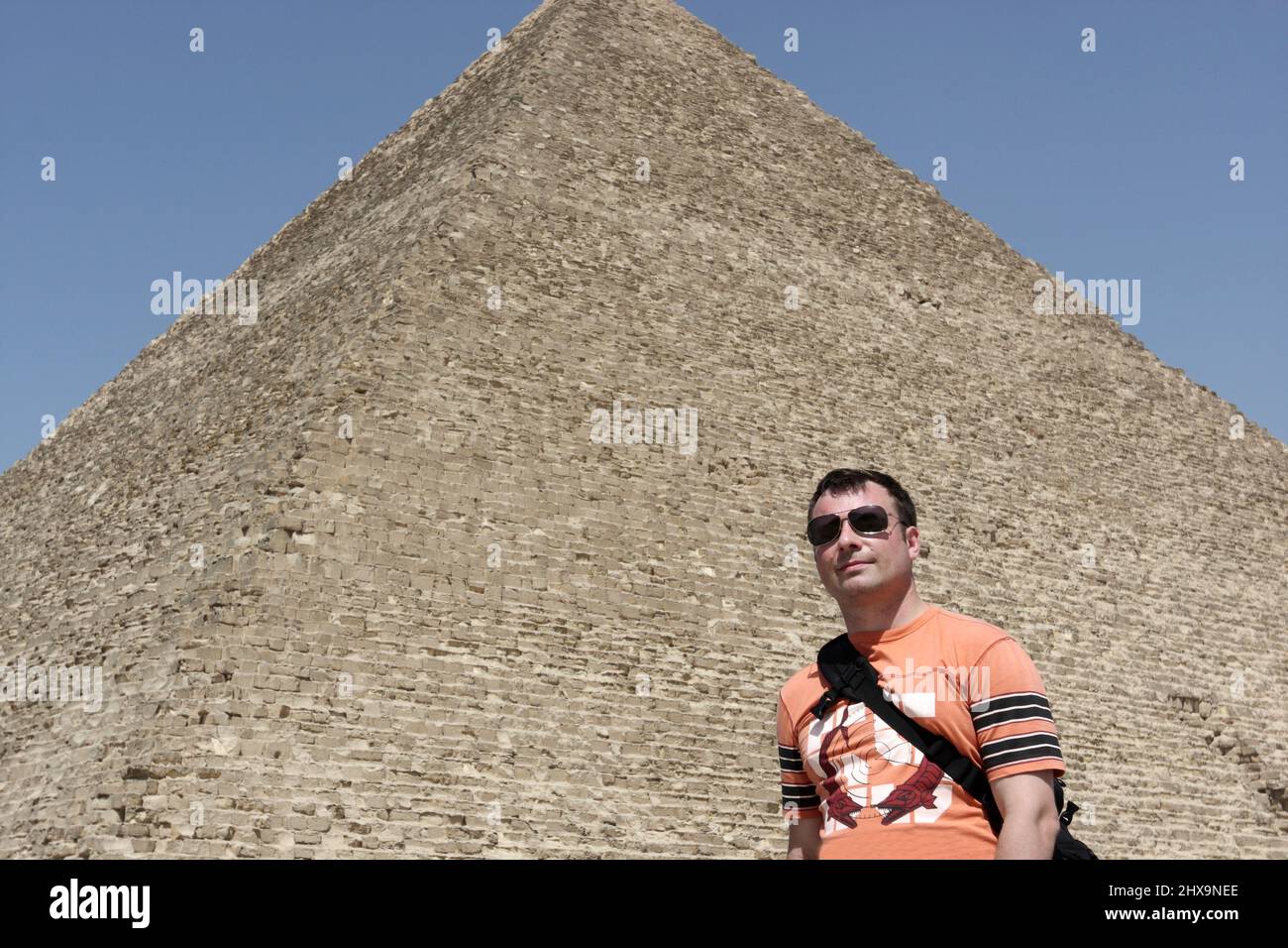 The man poses on great pyramid background, Egypt Stock Photo - Alamy