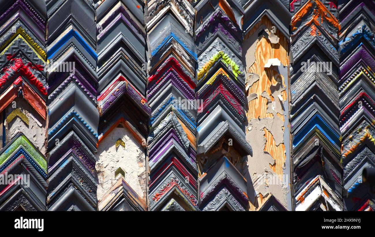 Wall is decorated with rows and rows of different styles of photo ...