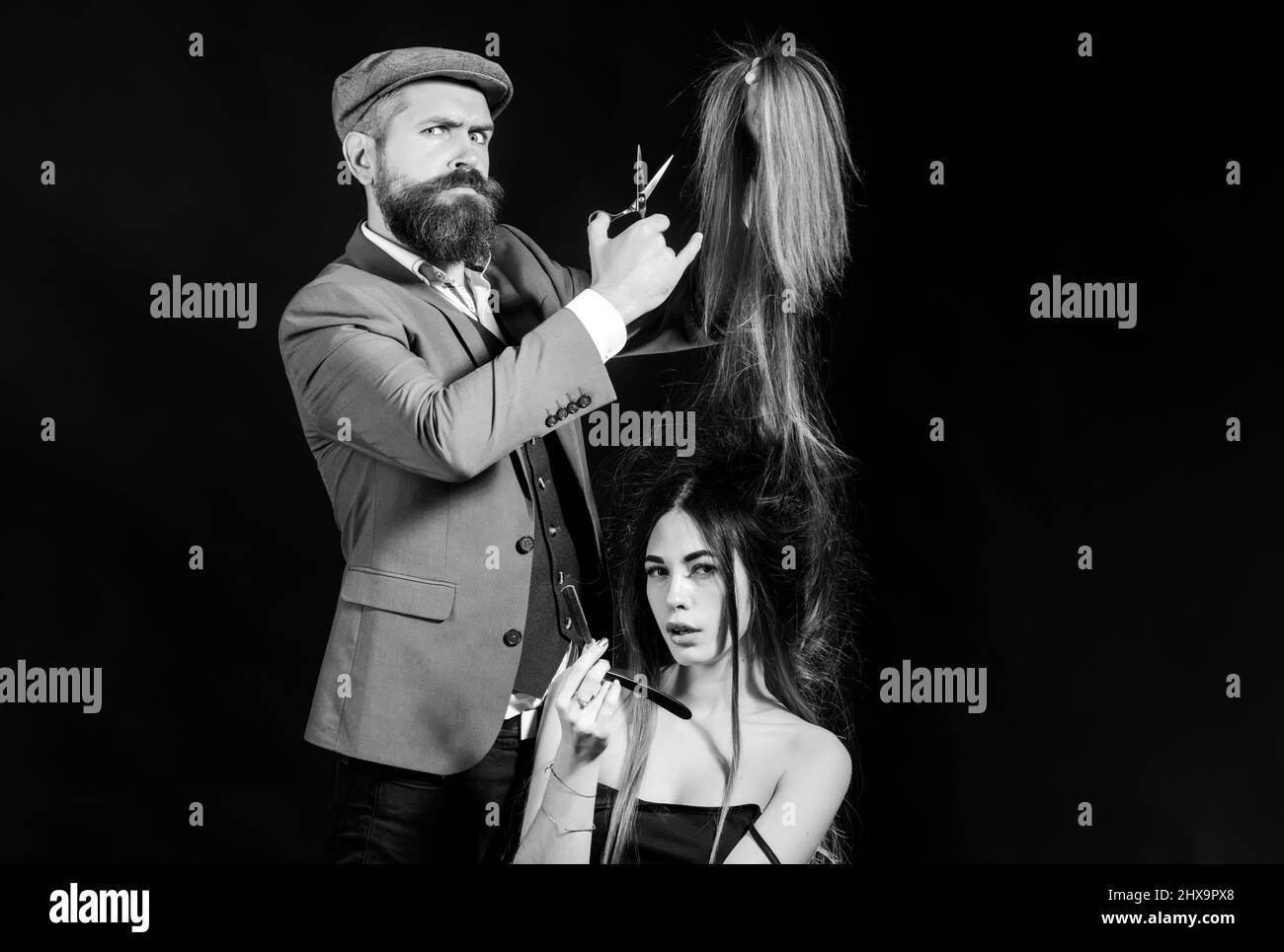 Barber scissors. Hairdresser makes hairstyle a woman with long hair ...