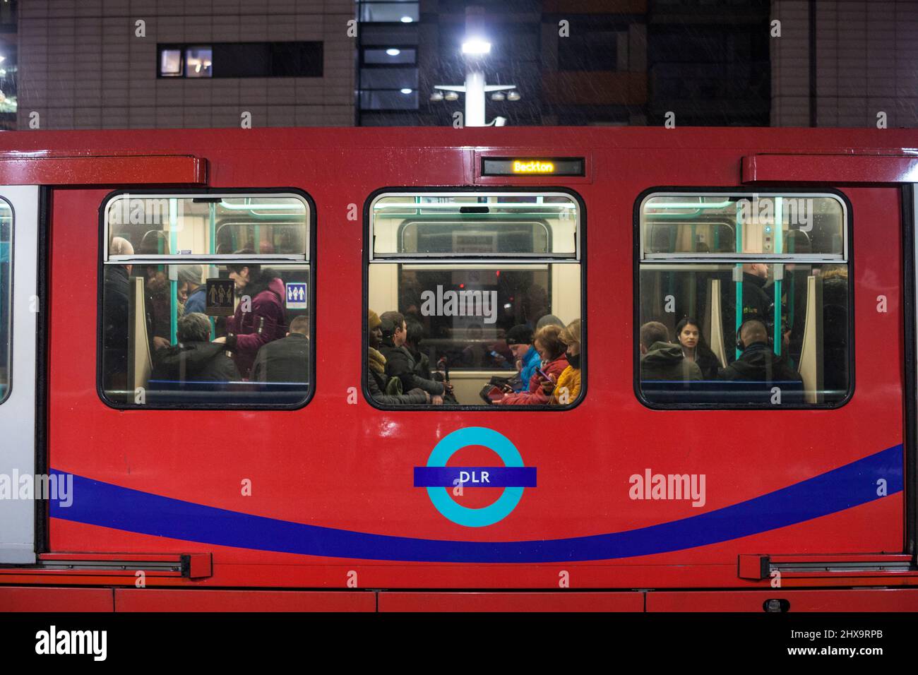 Passengers on a Docklands light railway train ( DLR train ) heading at ...
