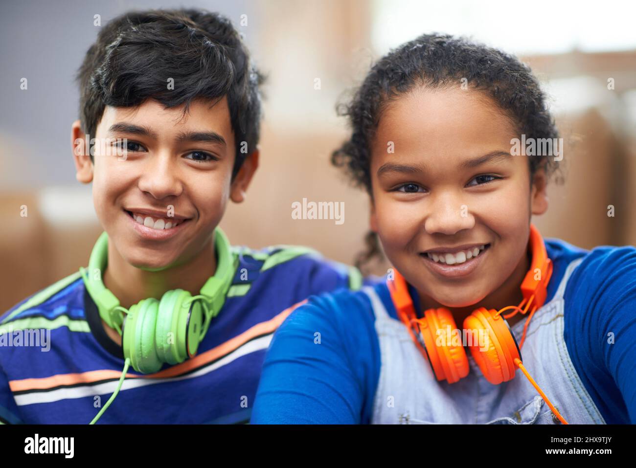We love our music. Portrait of a little brother and sister listening to ...