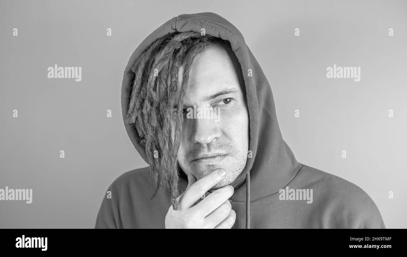 Young man with red dreadlocks in hood with thoughtful look. Stylish ...