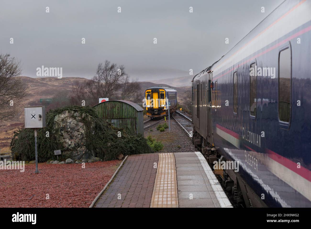 Caledonian sleeper train and Scotrail sprinter train crossing at ...