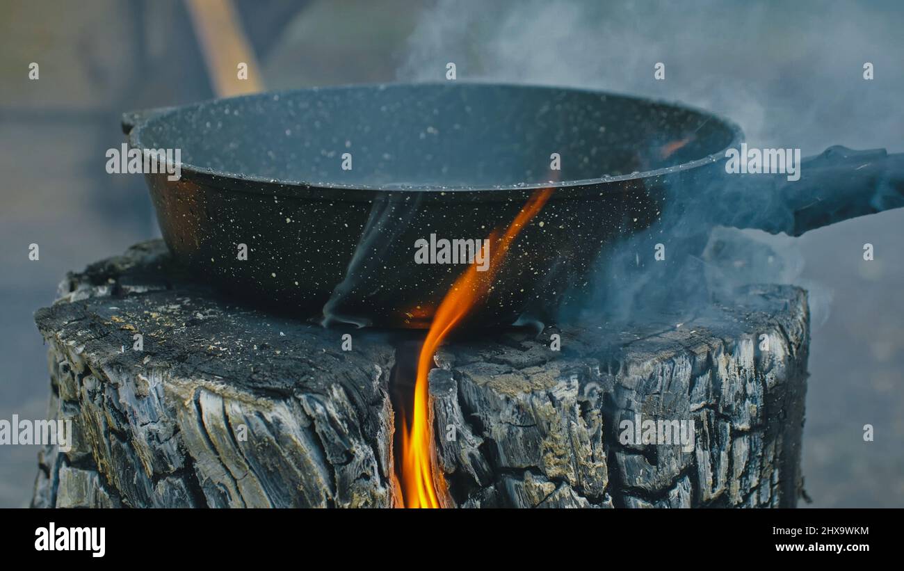Swedish or finnish log candle. Fire burning from inside the wooden log ...