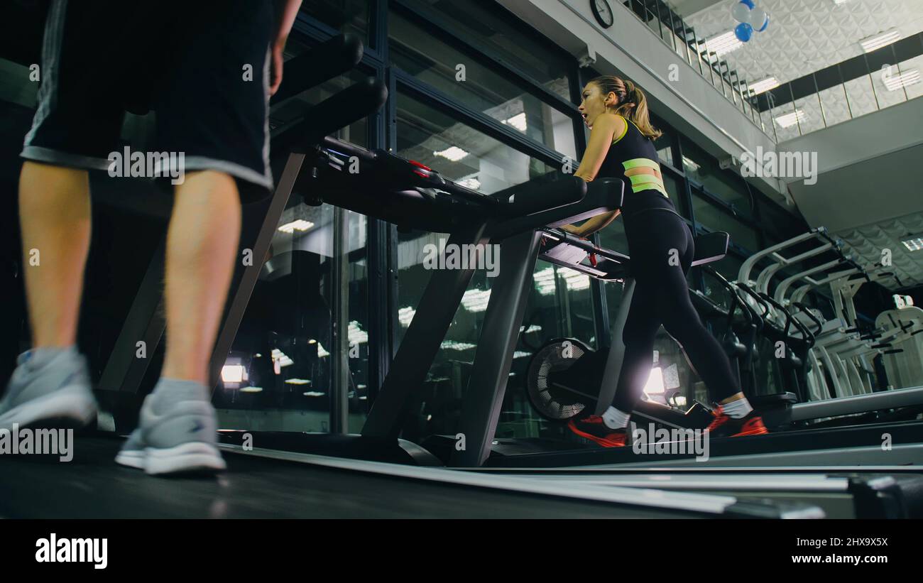 Fit Athletic Woman Running on the Treadmill, Doing Her Fitness Exercise ...