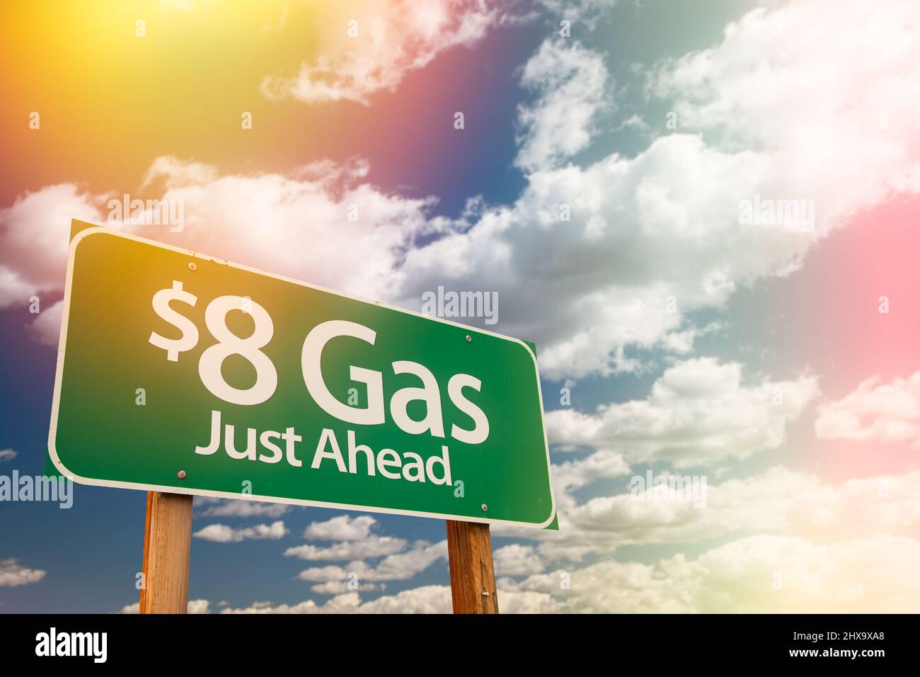 $8 Gas Green Road Sign Against Cloudy Sky Stock Photo - Alamy
