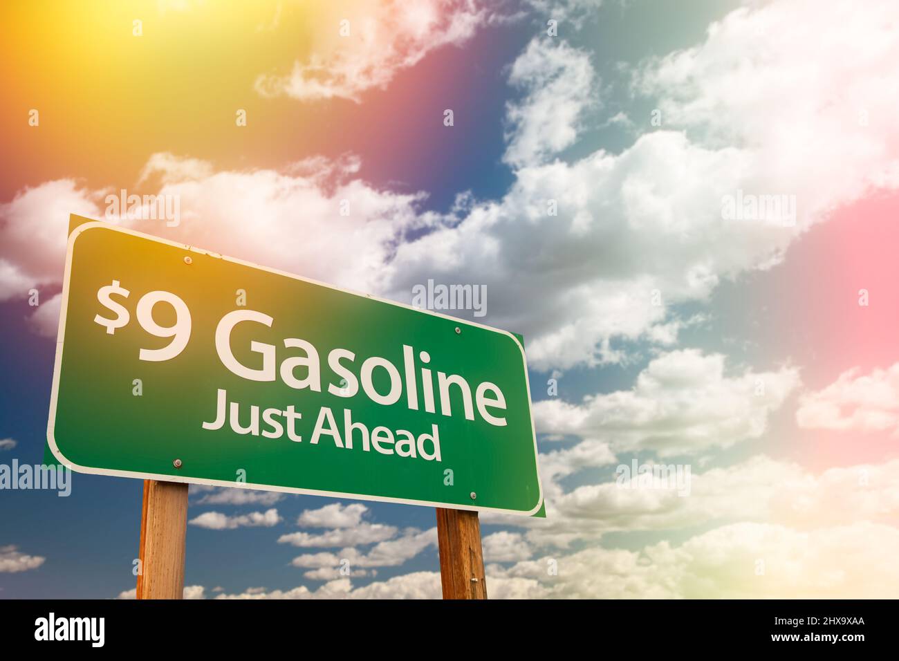 $9 Gas Green Road Sign Against Cloudy Sky Stock Photo - Alamy