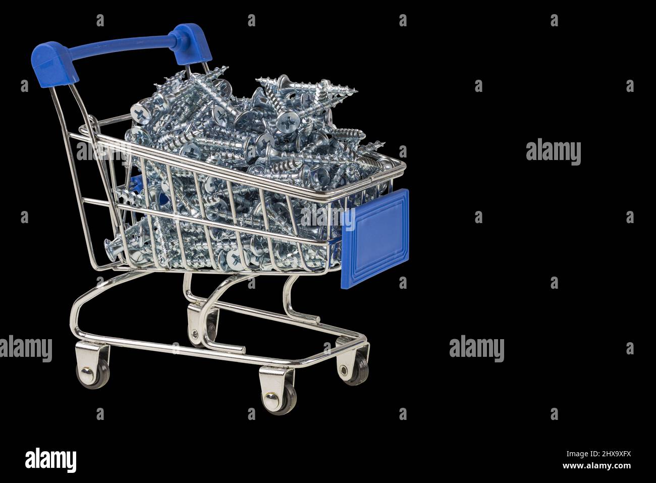 Close up view of toy shopping trolley filled with screws , isolated, on ...