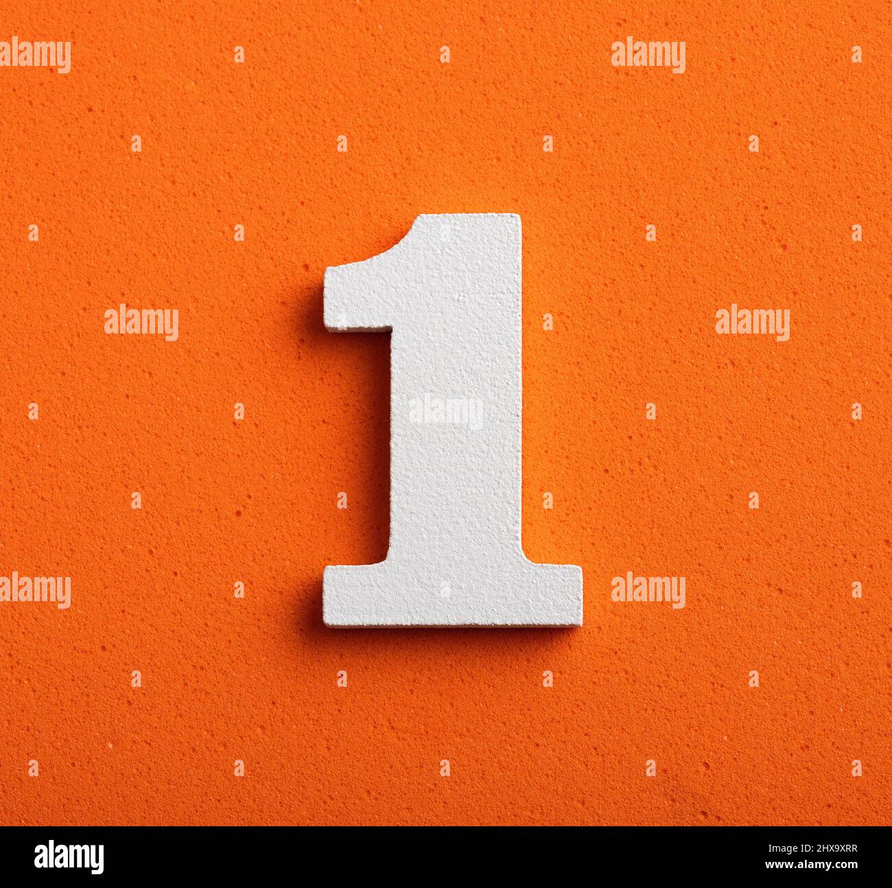 Number one - white number in wood on orange background Stock Photo - Alamy