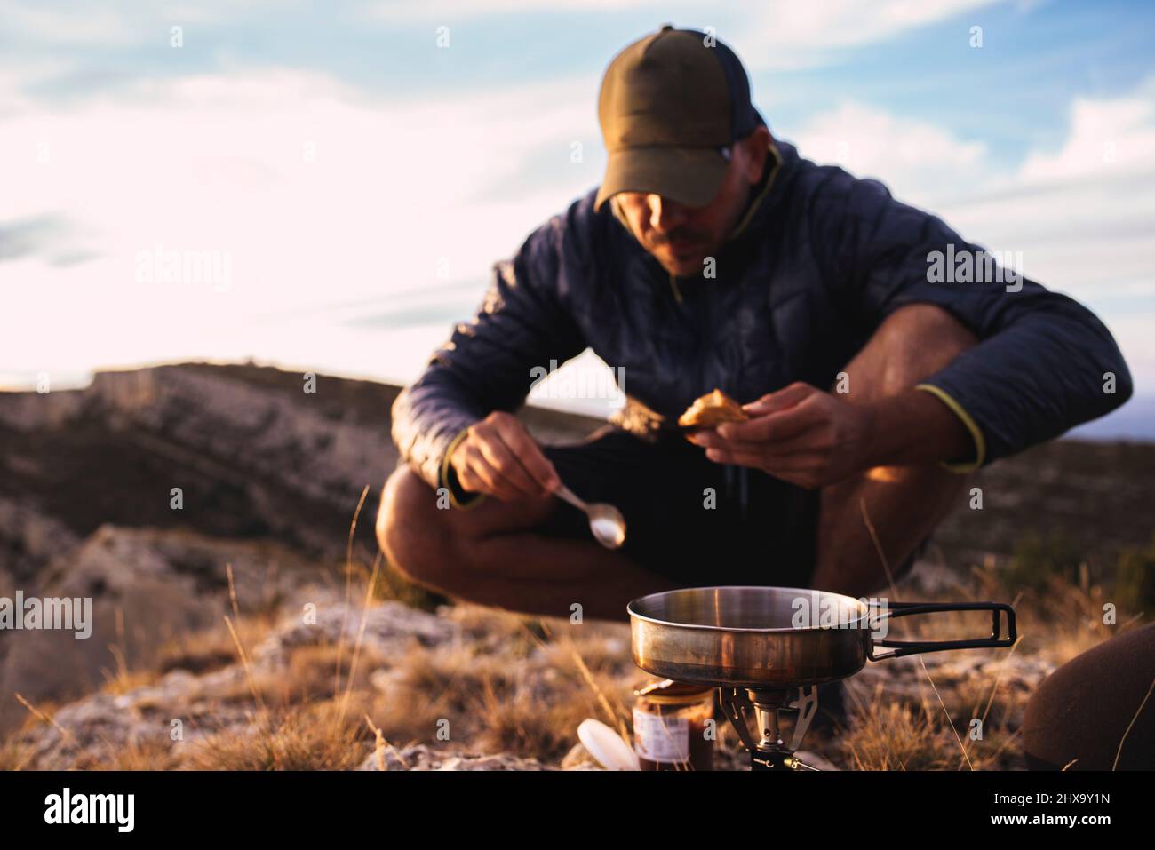 Front view of man cooking during a camping trip in the mountain Stock ...