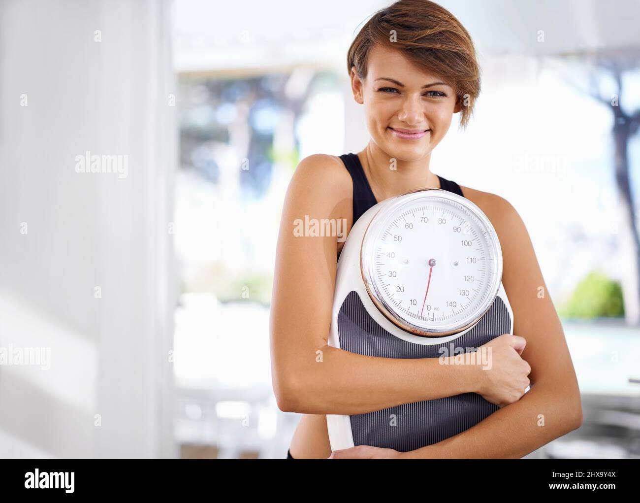 Good news from her scale today. A beautiful young woman standing ...