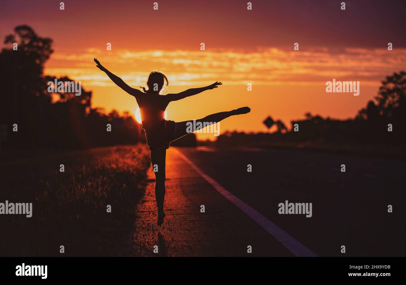 Young woman dancing in summer sunset sky outdoor. People freedom Stock ...