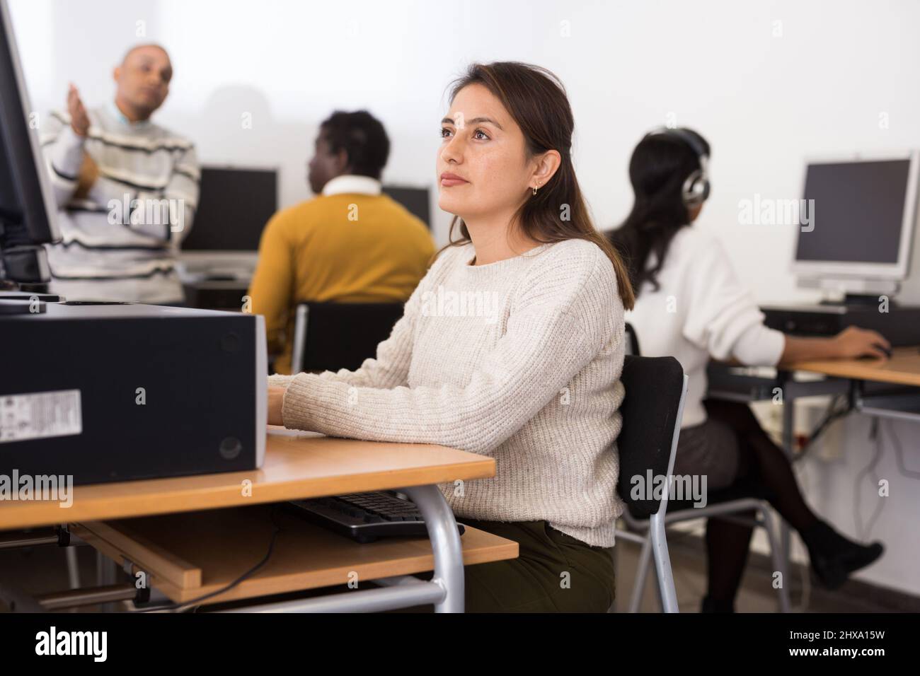 Young adult woman studying in computer class Stock Photo - Alamy