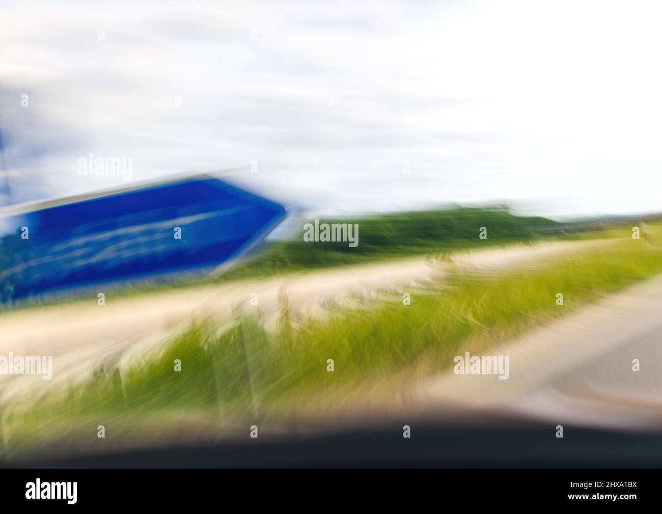 Distorted view by a driver during fast commuting on the highway of the ...