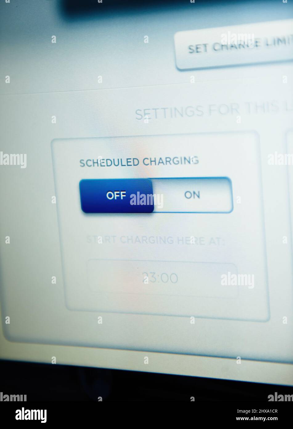 Close-up macro shot of a schedule charging button on the new electric ...