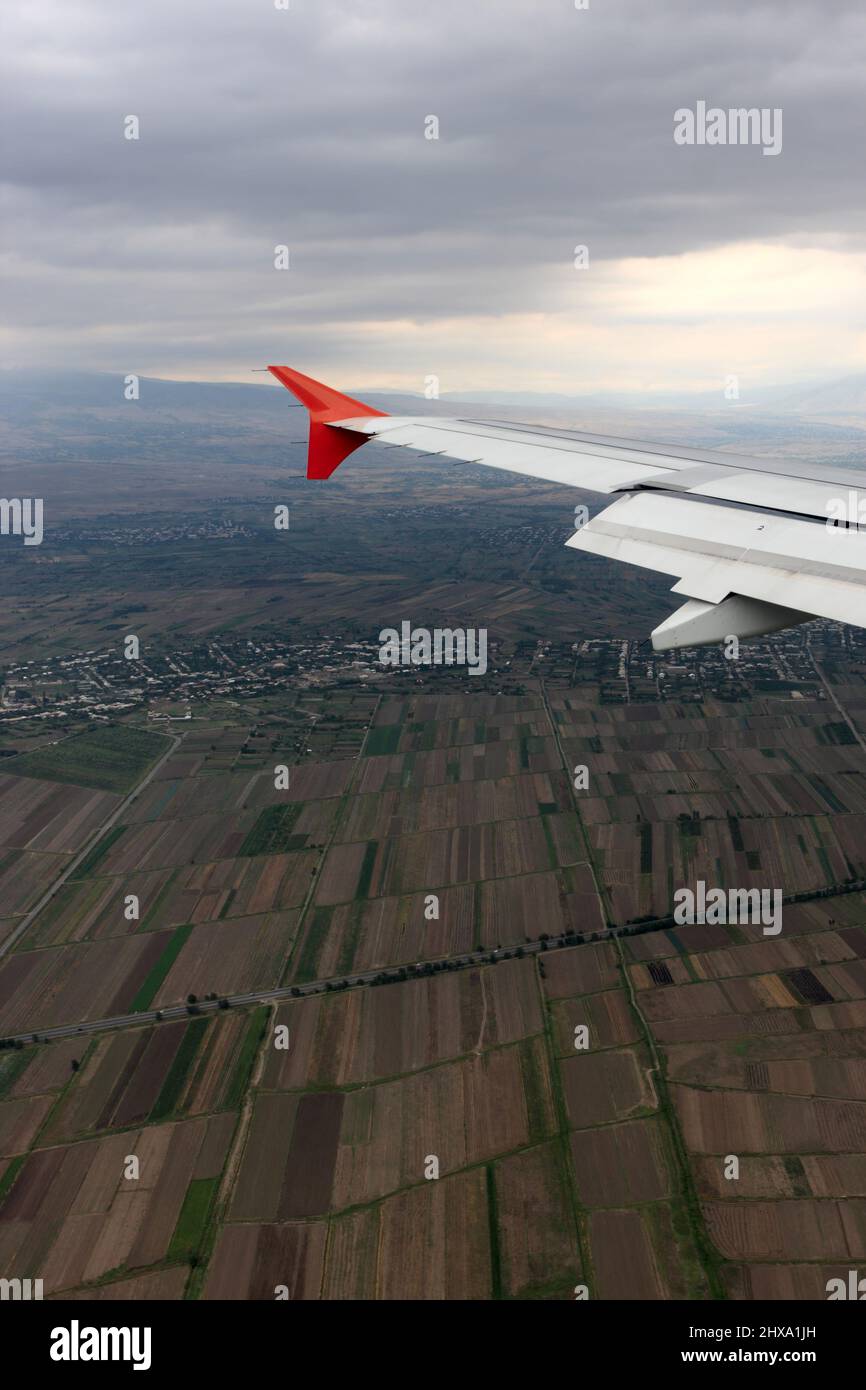The white wing of the flying airliner Stock Photo - Alamy