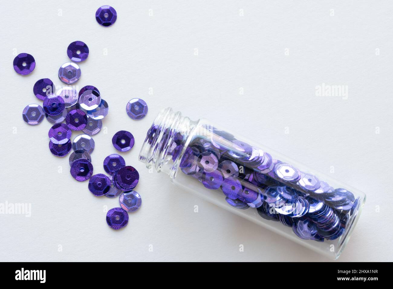 Dark Purple Sequins Spilled from a Jar Stock Photo - Alamy
