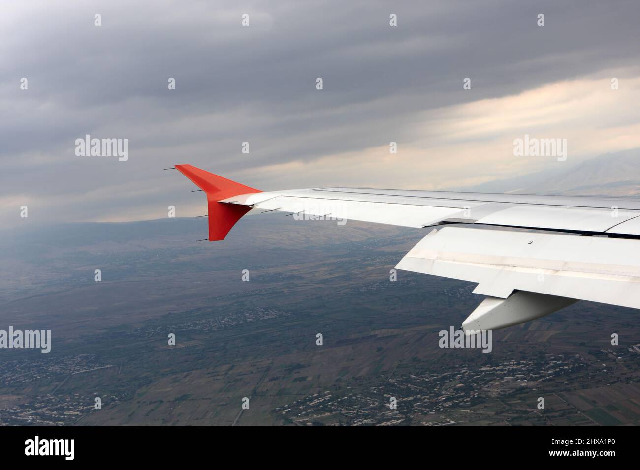 The white wing of the flying aircraft Stock Photo - Alamy
