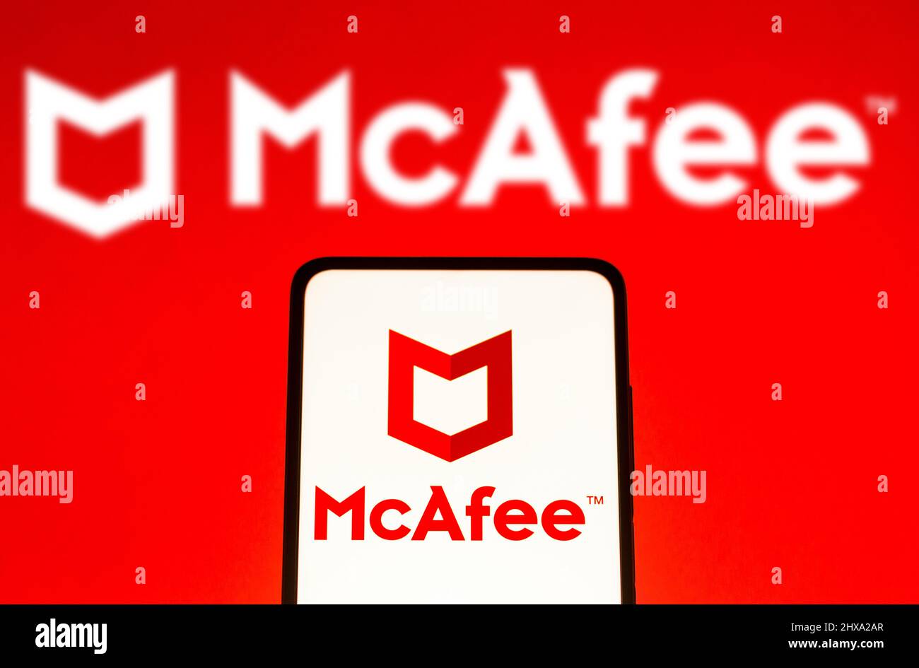 In this photo illustration the McAfee logo seen displayed on a ...