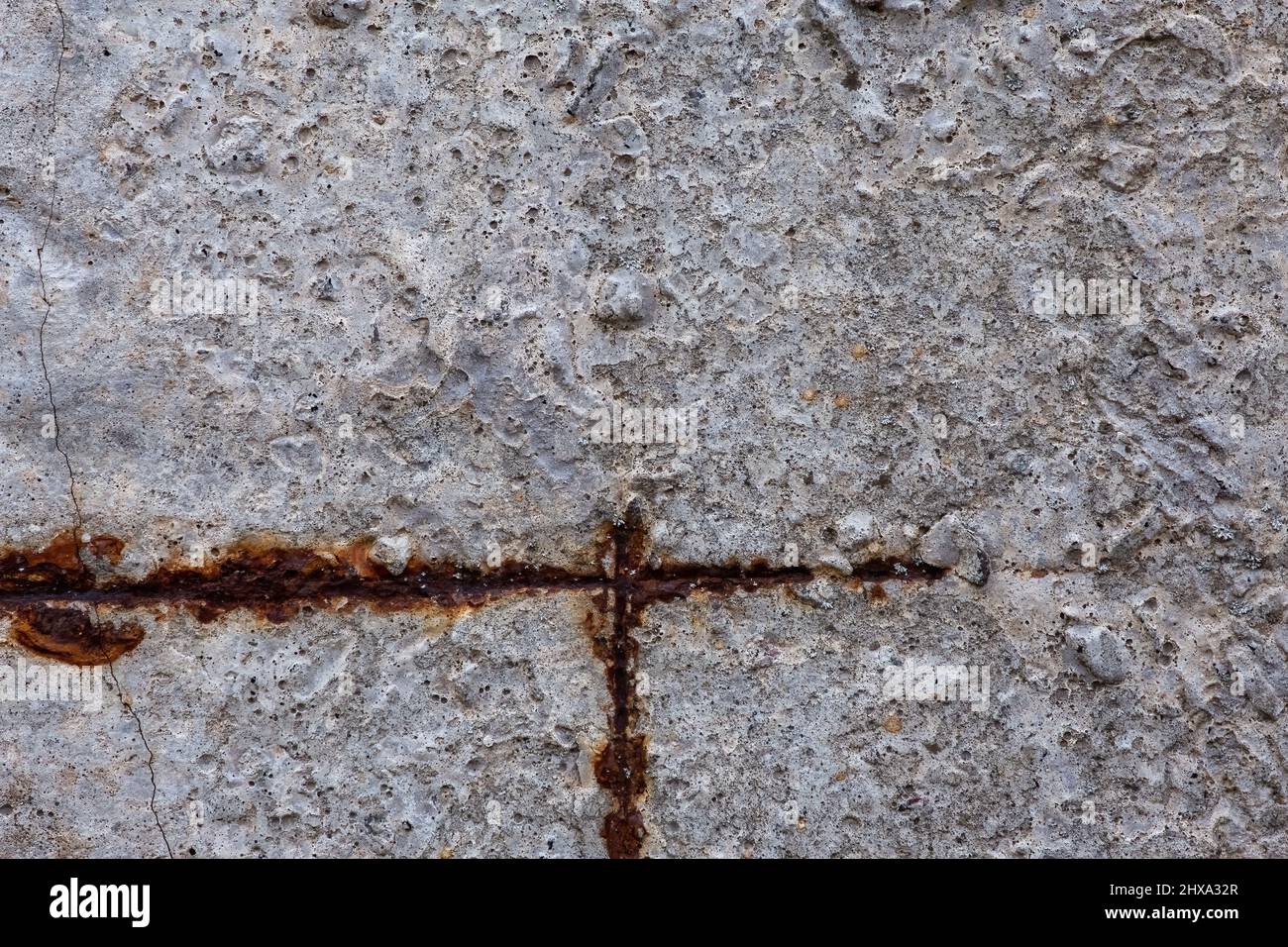 Macro fragment of an old gray concrete wall with rusty rebar. Material ...