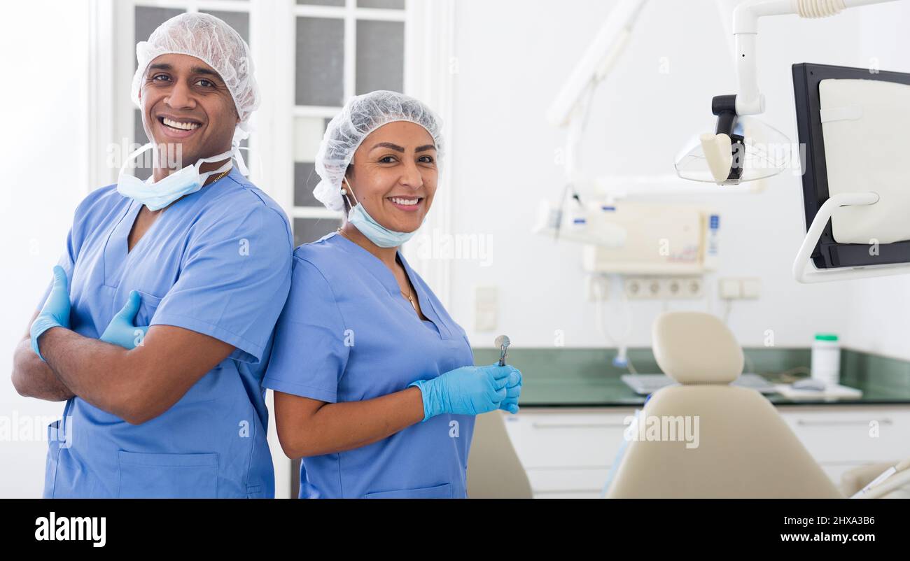 Two professional dentists standing in modern dental clinic Stock Photo ...