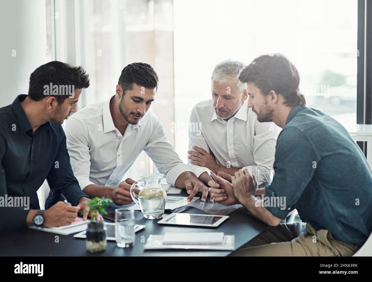 These guys know their business. Shot of a group of businessmen having a ...