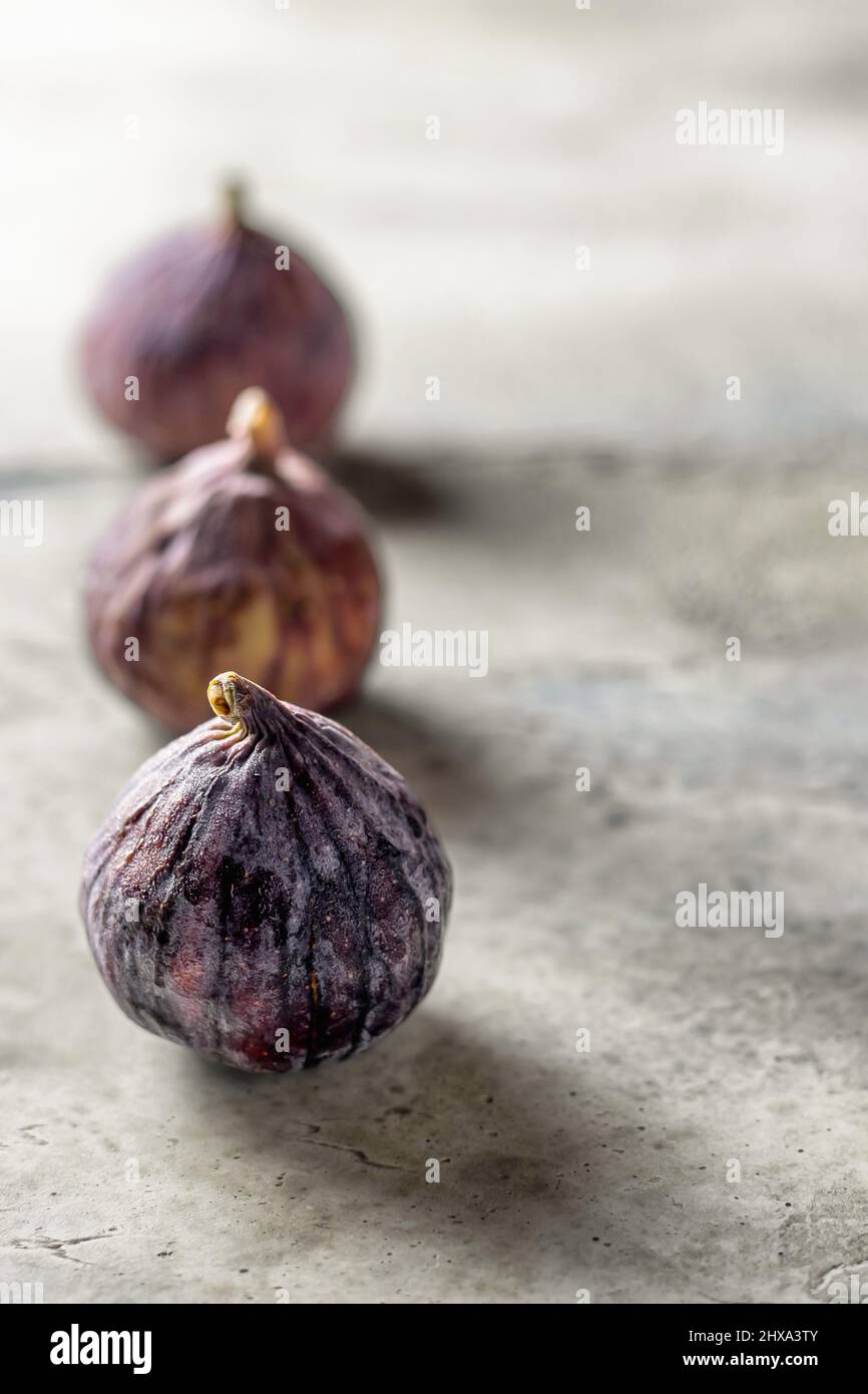 Close up composition of three whole figsin the left side isolated on ...