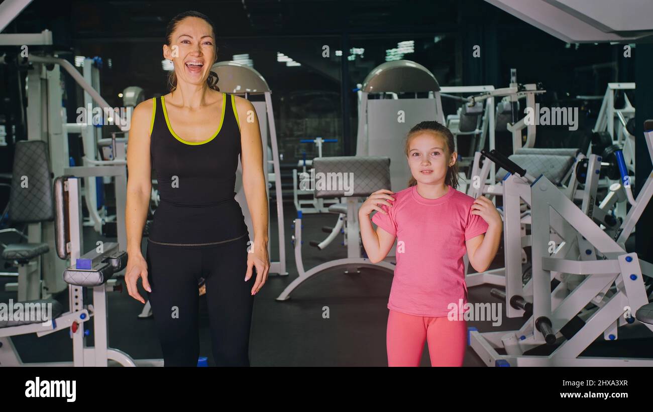 Mother and Daughter in the Gym, Family Performs Physical doing ...