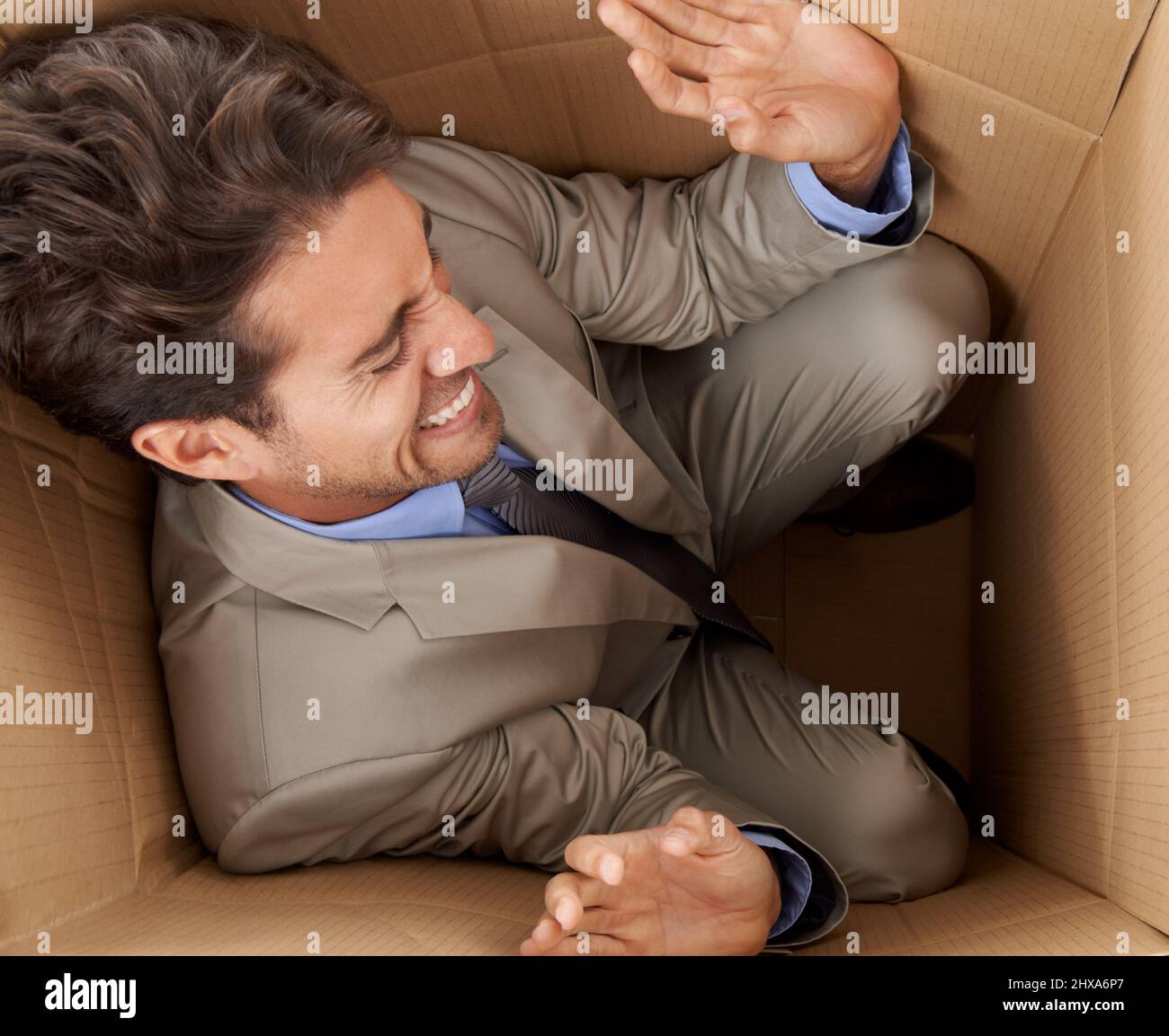 Trapped in his career. Concept shot of a young businessman trapped in a ...