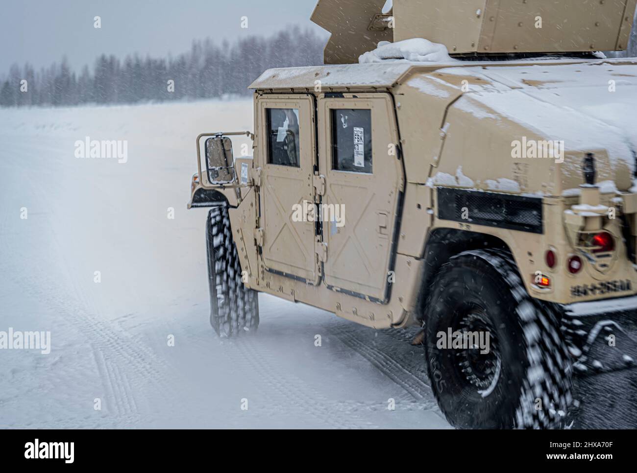U.S. Florida Army National Guardsmen drive a humvee through the snow ...