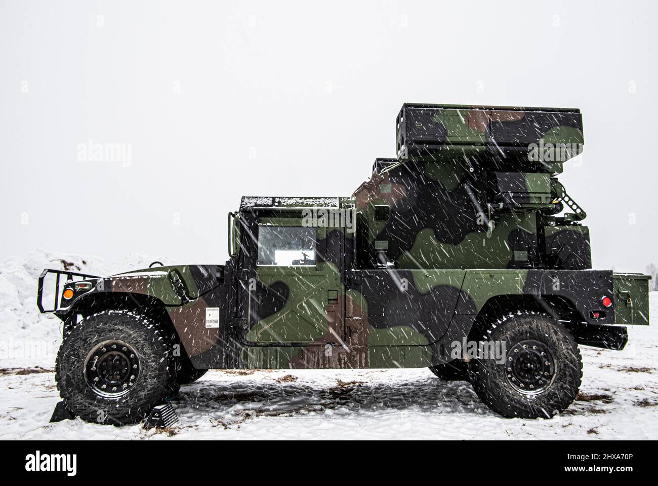 An Avenger air defense system is staged as it snows during Exercise ...