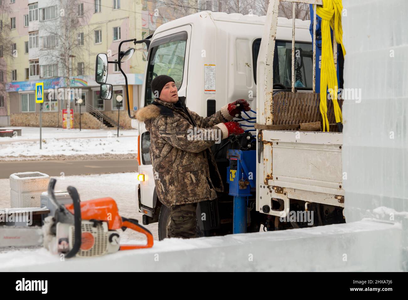 Portrait of a hydraulic crane driver at the construction of an ice town ...